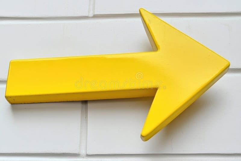Bright Yellow Arrow Sign on White Brick Wall for Directional Design ...
