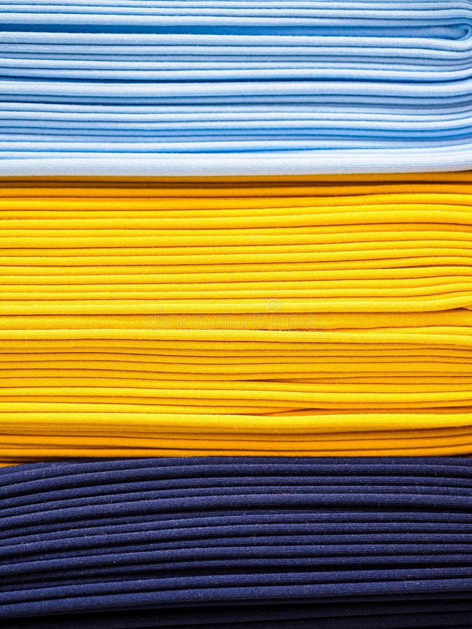 Bright Yellow and Blue Fabric Laid in Layers, Close-up. Background with ...