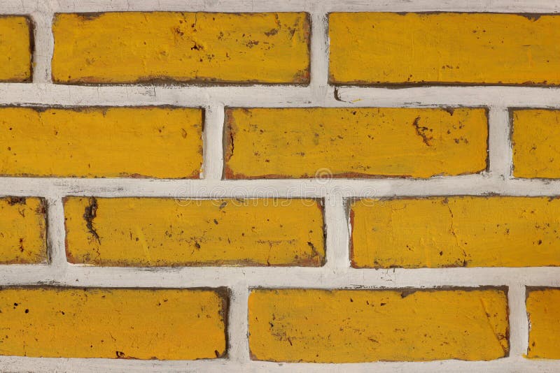 Bright Yellow Brick Wall with White Mortar, Showcasing a Rustic and ...