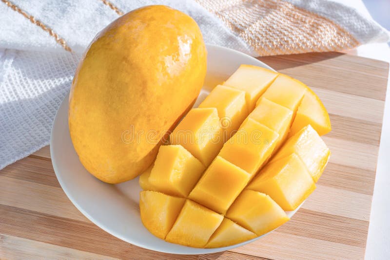 Bright Yellow Cube Sliced Fresh Mango on the White Plate on Wooden ... Bright Yellow Cube Sliced Fresh Mango on the White Plate on Wooden ...