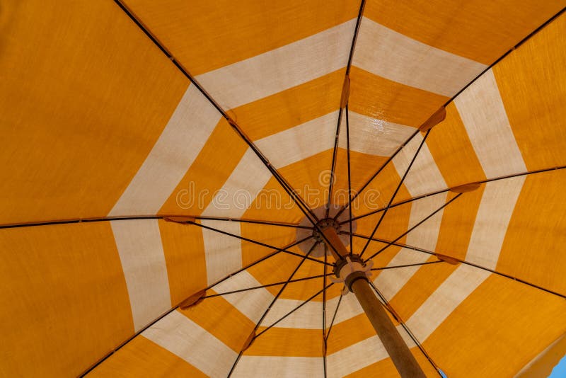 Bright Yellow Parasol Stretched Out on the Beach Stock Image - Image of ...