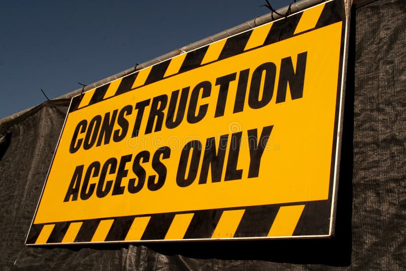 Bright Yellow Sign with Black Capital Letters Stating Construction ...