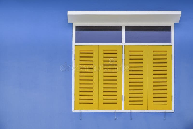 Bright Yellow Window on Vivid Blue Wall Stock Image - Image of blue ...