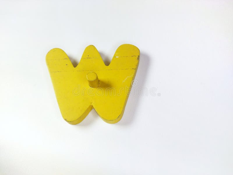 A Bright Yellow Wooden Object in the Shape of the Letter W, Isolated on ...