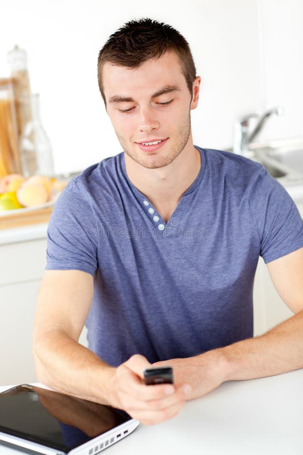 Bright Young Man Sending a Text in the Living-room Stock Photo - Image ...