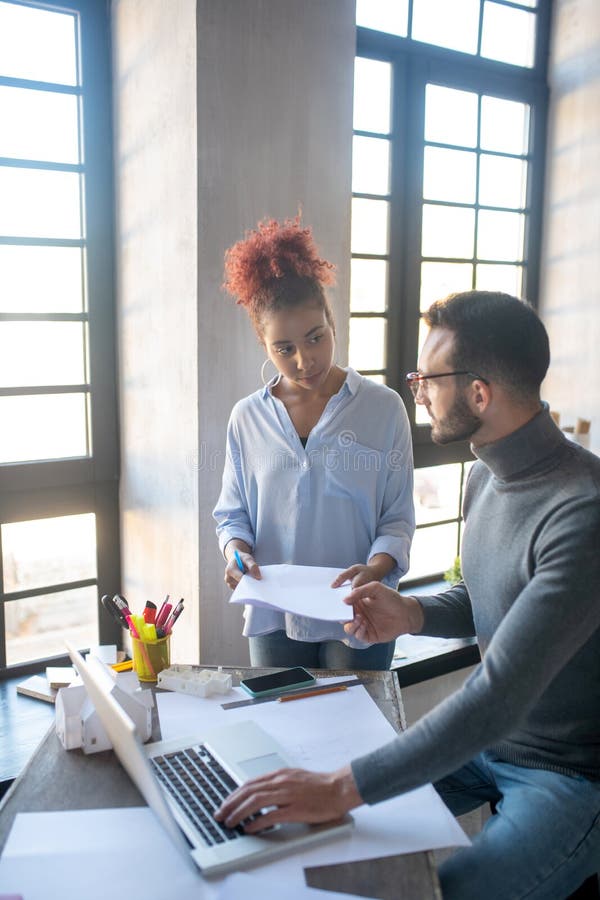 Curly Secretary Speaking with Interior Designer about Clients Stock ...