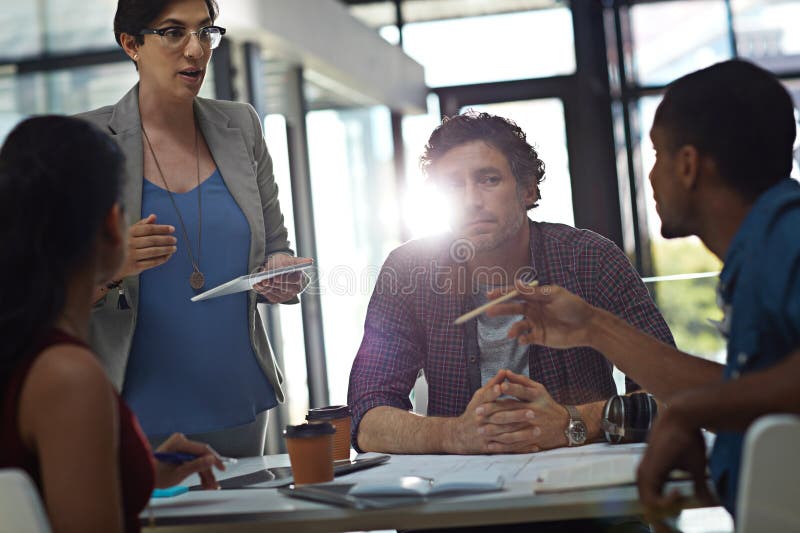 Bringing Their Ideas To the Table. a Group of Colleagues Meeting in the ...