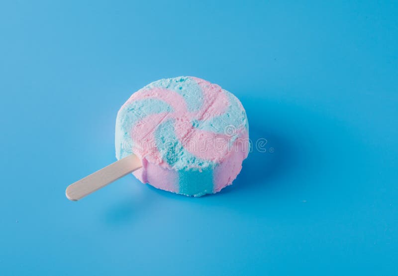Briquette of Round Popsicles on a Stick on a Blue Background Stock ...