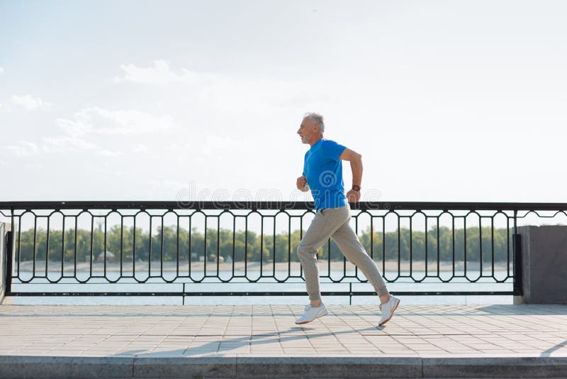 Side View of Energetic Senior Man Jogging on the Bridge Stock Image ...