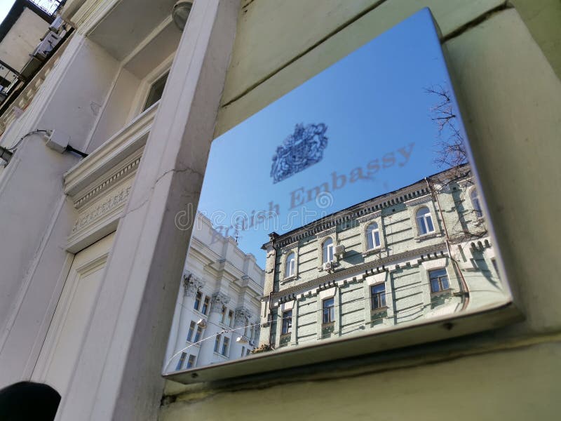 British Embassy Sign with Reflection of City Buildings and Blue Sky ...