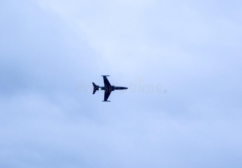 A Large Fighter Jet in the Sky Flashing a Light on Its Rear Tail Stock ...