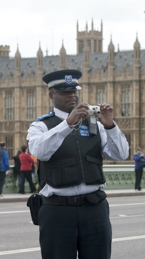 British Policeman with Photo Camera Editorial Stock Photo - Image of ...