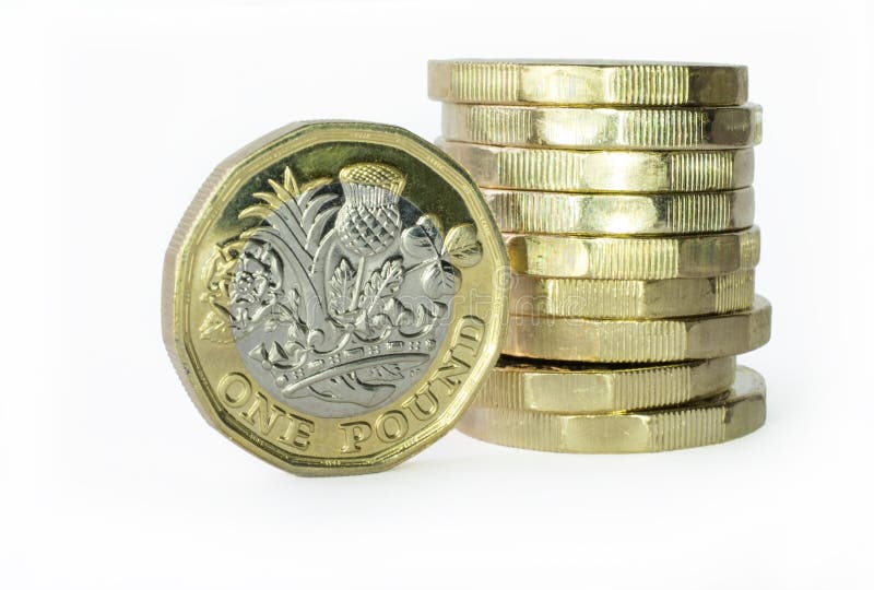 British Pound Coin Next To a Stack of Coins Stock Photo - Image of ...