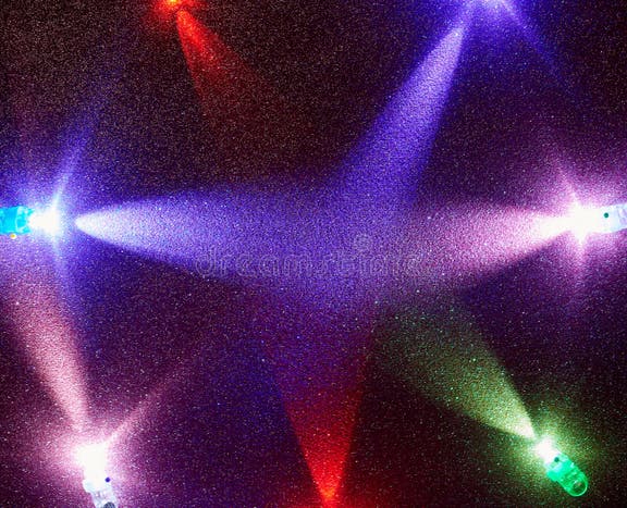 On a Broad Background, Multi-colored Rays of Light Shine from Different ...