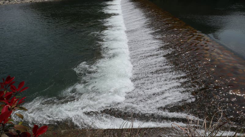 A Broad Dam Spans Across the River Stock Image - Image of surging ...