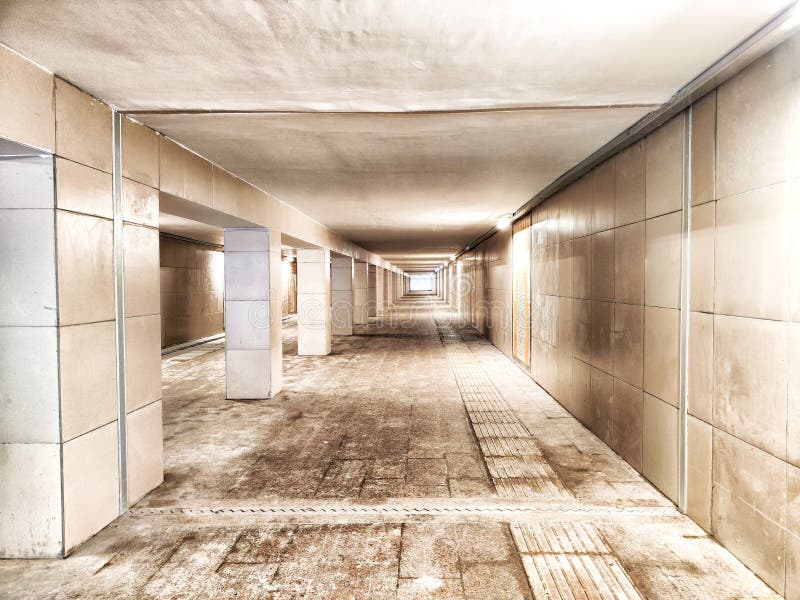 A Broad Underground Passageway Features Clean Tiles and Bright Lights ...