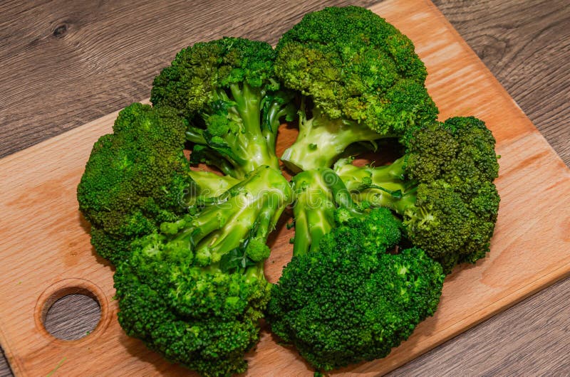 Broccoli on a Cutting Board in the Kitchen Stock Image - Image of ...