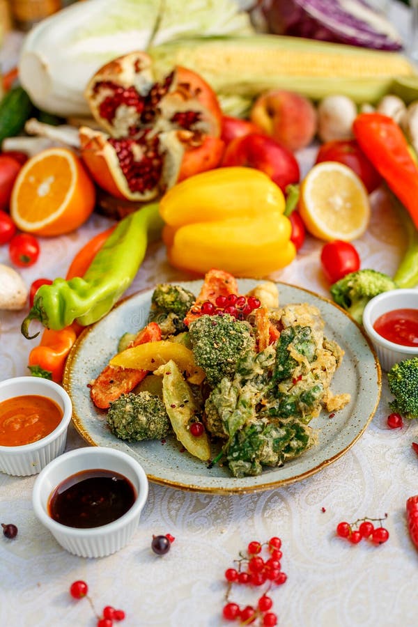 Broccoli Fried in Breading with Vegetables with Sauces on a Decorated ...