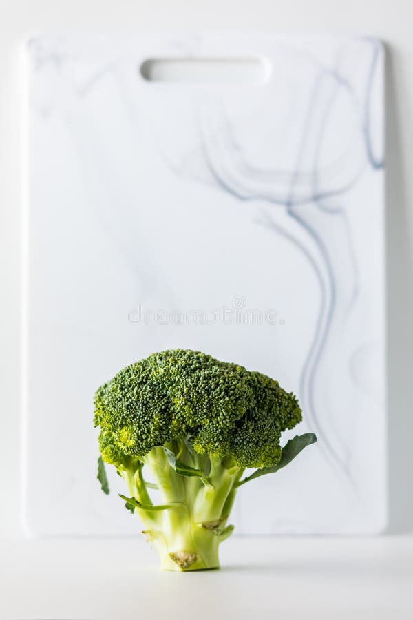 A Broccoli Stalk Standing in Front of a Cutting Board. Stock Image ...