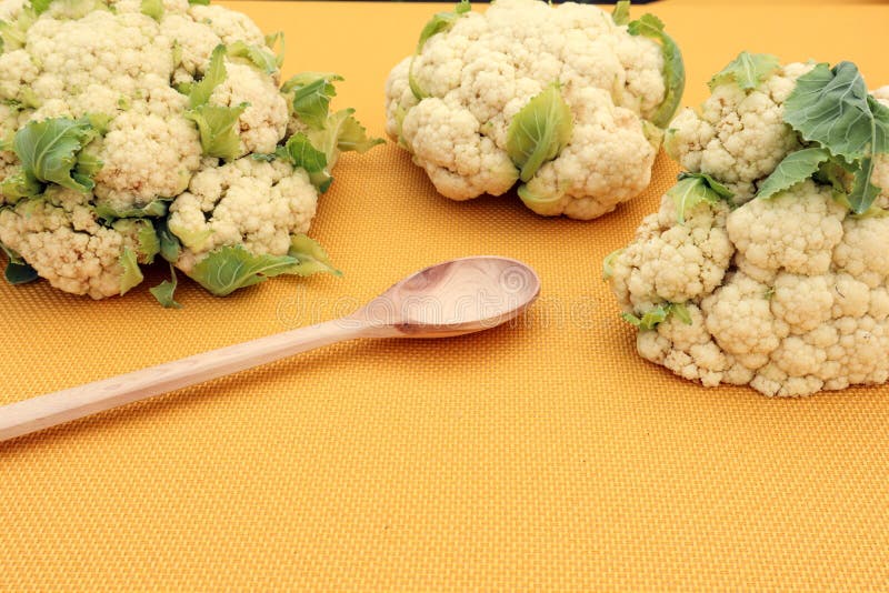 Broccoli on a Yellow Background with a Wooden Spoon, Close-up, Side ...