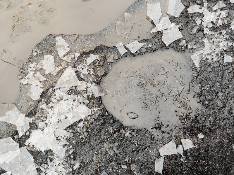 Broken Asphalt. Pit on the Road in the Winter, Surrounded by Ice Stock ...