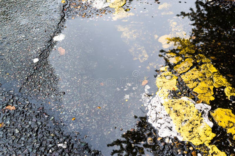 Broken Asphalt with a Rain Puddle Stock Photo - Image of water, surface ...