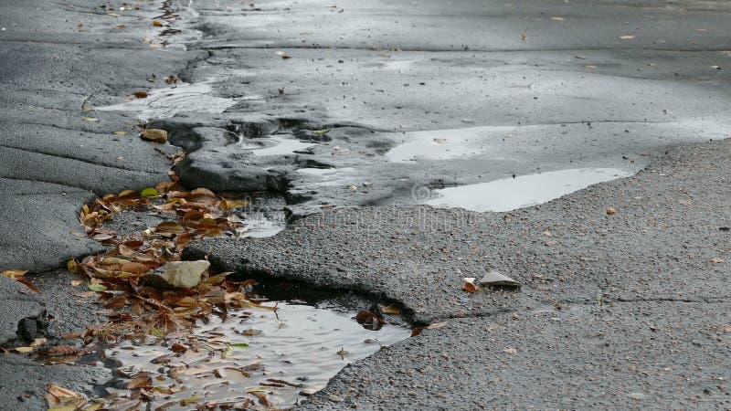 Broken Asphalt Rain Tarmac Pits in Pool Floating Leaves are Falling ...