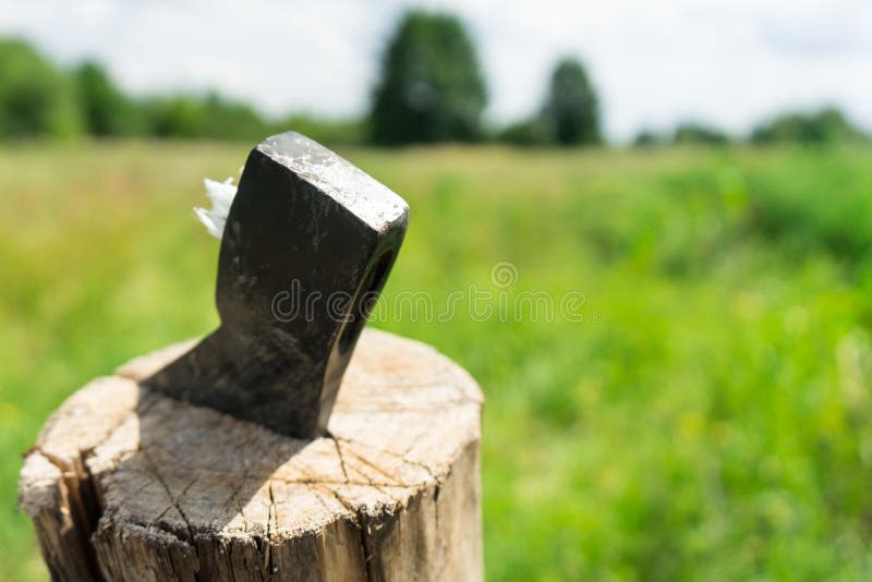 Broken Axe on the Background of Green Meadows. Stock Image - Image of ...