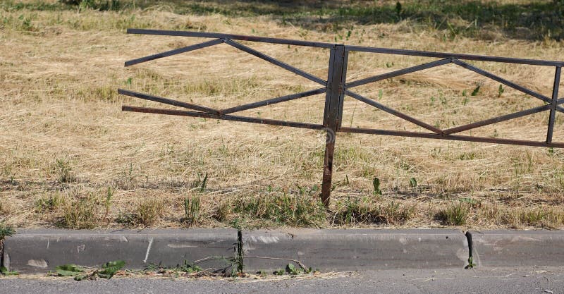 Broken Black Metal Fence on a Lawn with Mown Grass Stock Photo - Image ...