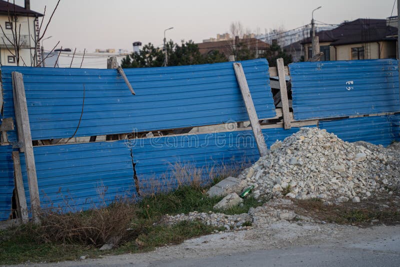 Broken Blue Fence at the Construction Site. Dangerous Place Stock Photo ...