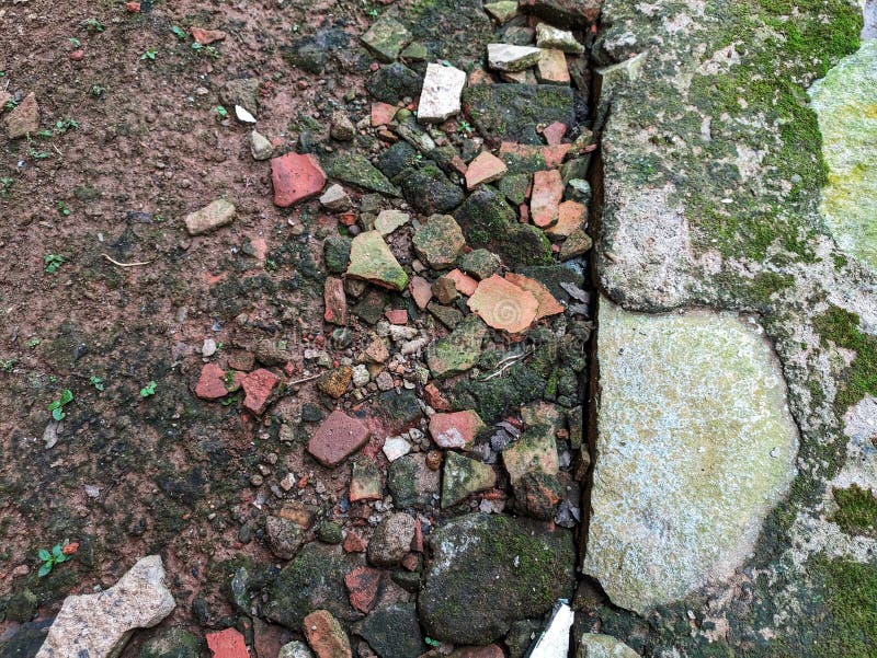 Broken Bricks and Gravel beside a Moss-covered Stone Wall. Stock Photo ...