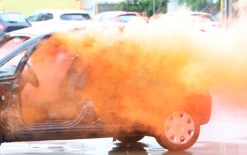 Broken Car Emitting Thick Orange Smoke during a Fire Department ...