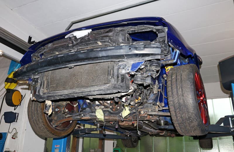 A Broken Car on a Lift in a Garage Stock Image - Image of business ...