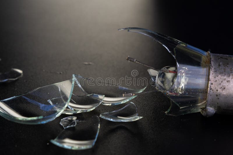 Broken Car Light Bulb on Black Background. Filament and Glass Shards ...