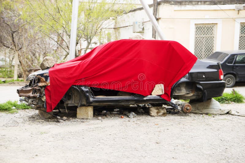 Broken Car is in the Yard Covered with Red Cloth Stock Photo - Image of ...