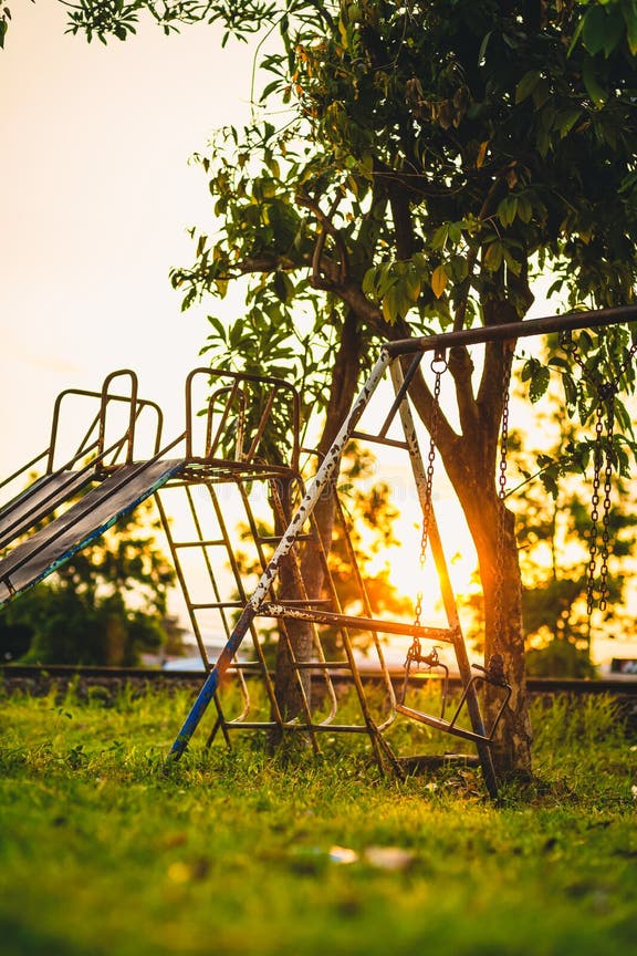 Broken Chain Swing in Playground and Light of Sunset Stock Photo ...