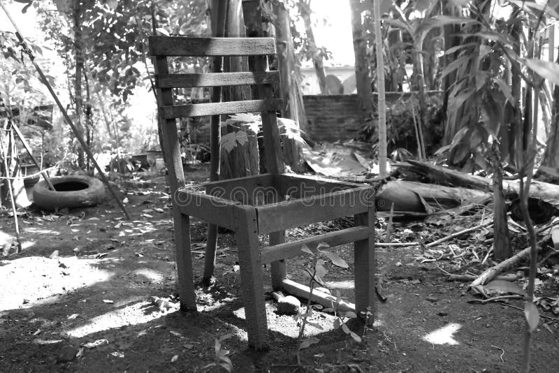 A Broken Chair in a Home Garden Stock Photo - Image of black, tree ...