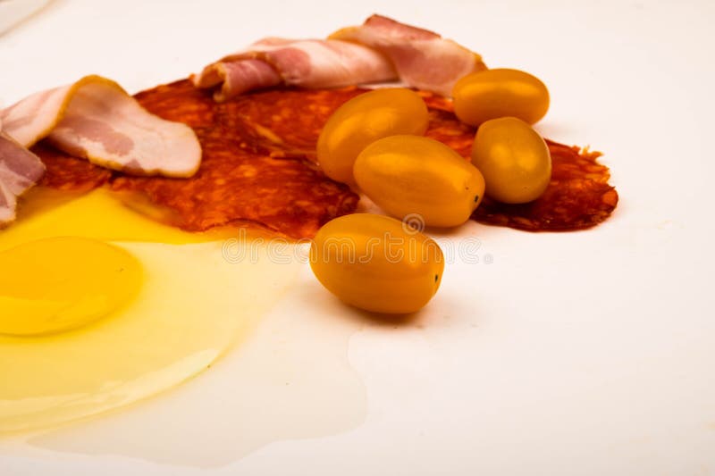 A Broken Chicken Egg without a Shell, Slices of Sausage and Bacon and ...