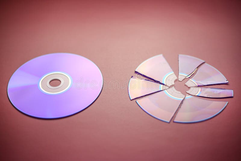 Broken Compact Disc Divided into Parts and a Whole Compact Disc Close ...