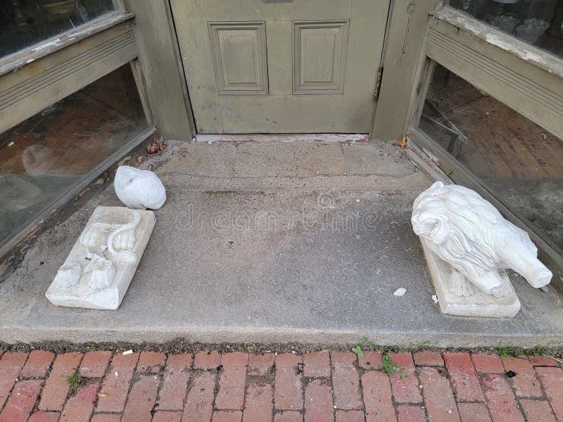 Broken or Damaged Lion Statues on the Ground with Door Stock Photo ...