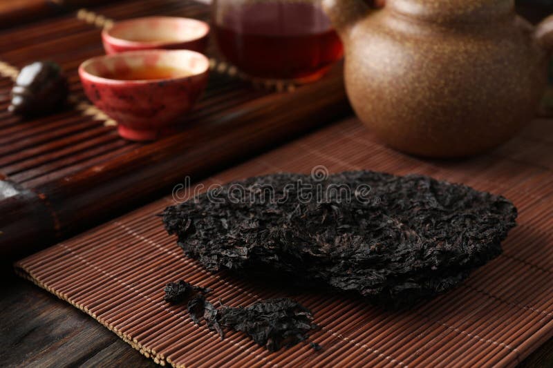 Broken Disc Shaped Pu-erh Tea and Knife on Wooden Table Stock Photo ...