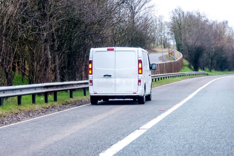 A Broken Down White Van Sitting on the Hard Shoulder with it S Hazard ...