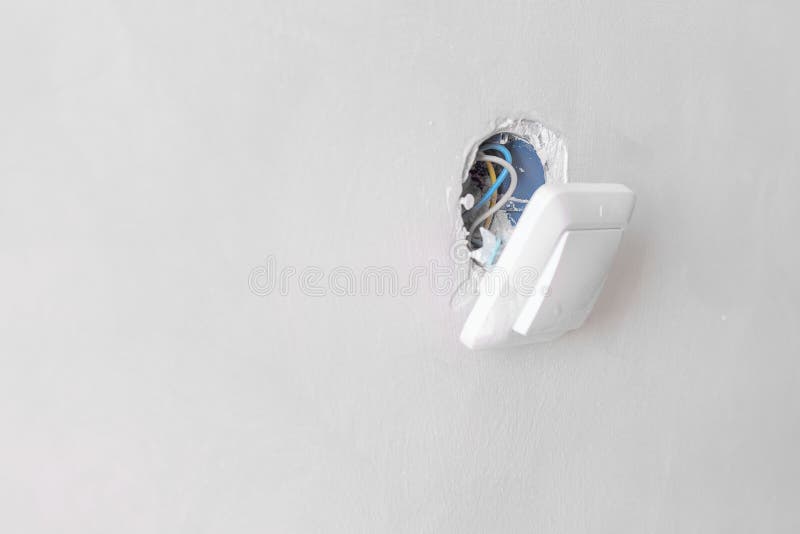 A Broken Electric Switch on a White Wall Stock Photo - Image of control ...