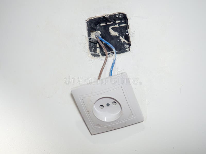 Broken Electrical Socket on the Wall. Disassembled Device. White Wall ...