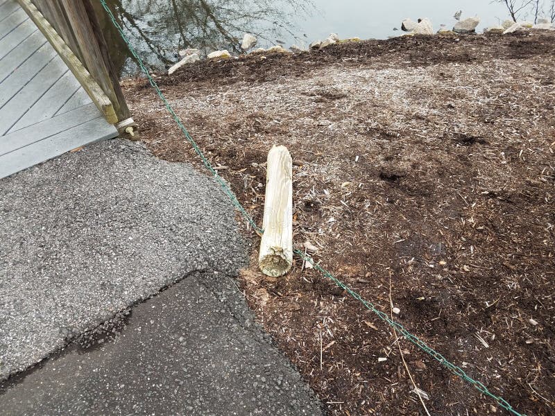 Broken Fence Post with Chain and Asphalt Path Stock Photo - Image of ...