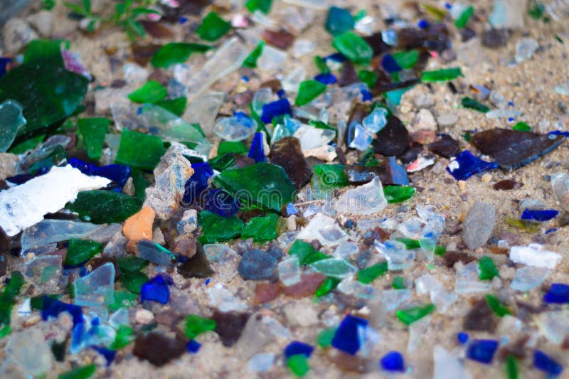 Broken Glass Bottles on White Sand. Bottles is Green and Blue Colour ...