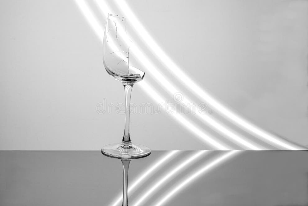 Broken Glass in the Rays of Light and Reflection on a Glass Table Stock ...