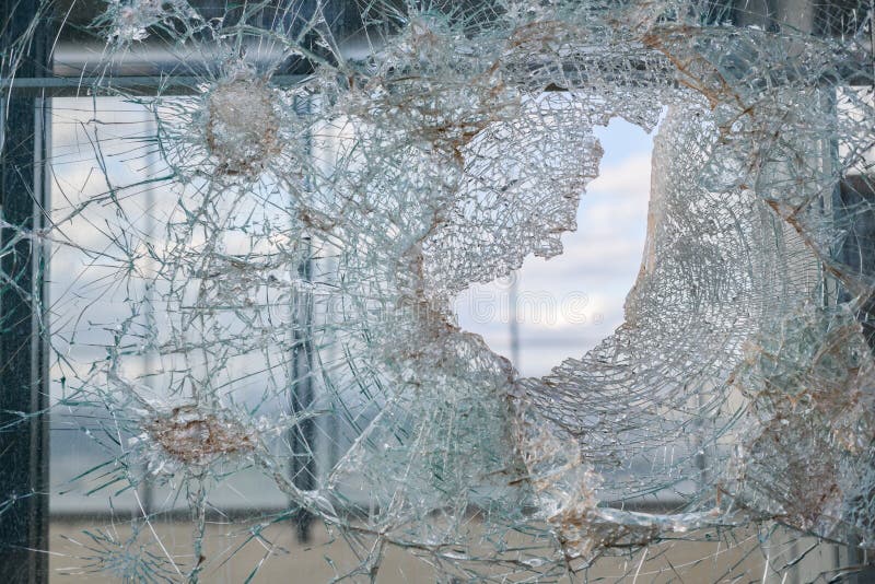 Broken Glass in the Windows of a Large Modern House Against the Blue ...