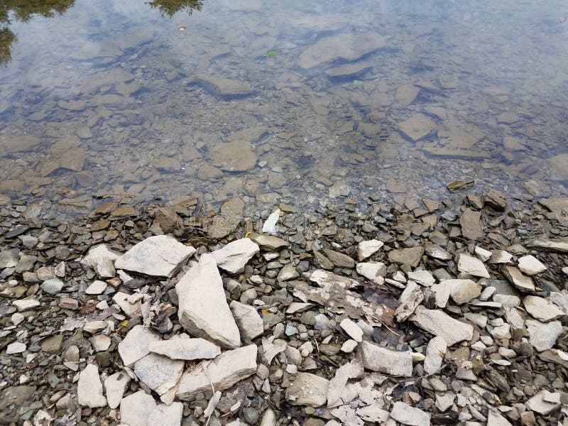 Broken Grey Rocks and Water at Shore of River or Lake Stock Image ...
