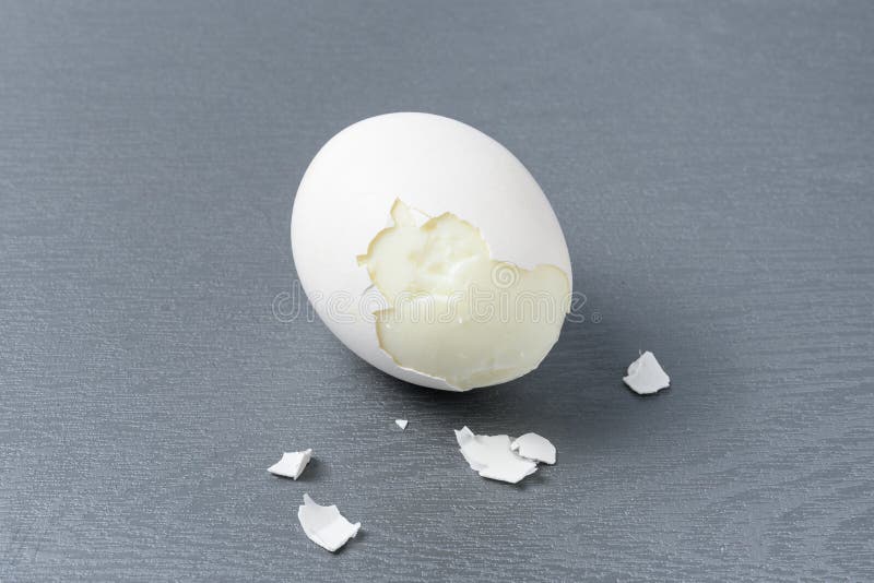 Broken Hard-boiled Egg with Cracks and Pieces of Shell on the Surface ...